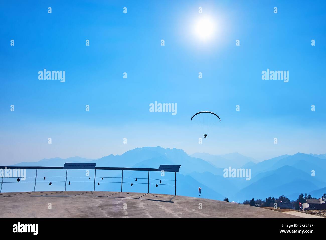 The glider aircraft over Cardada Cimetta against the foggy Alps, Ticino ...