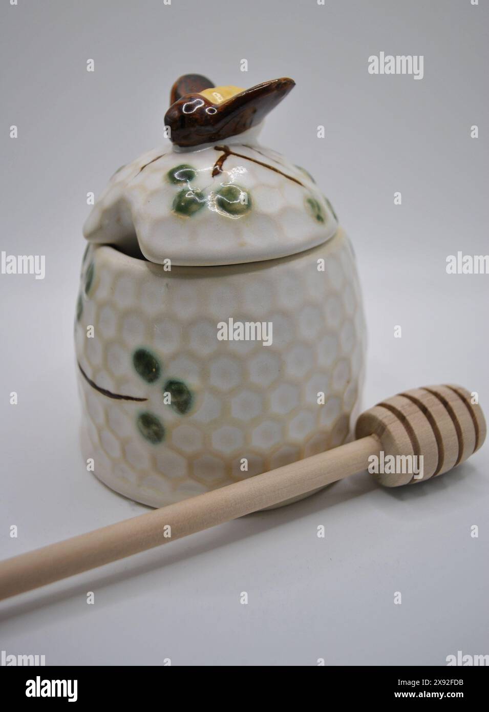 Ceramic Beehive Honey Pot and Wooden Dipper on White Background Stock ...