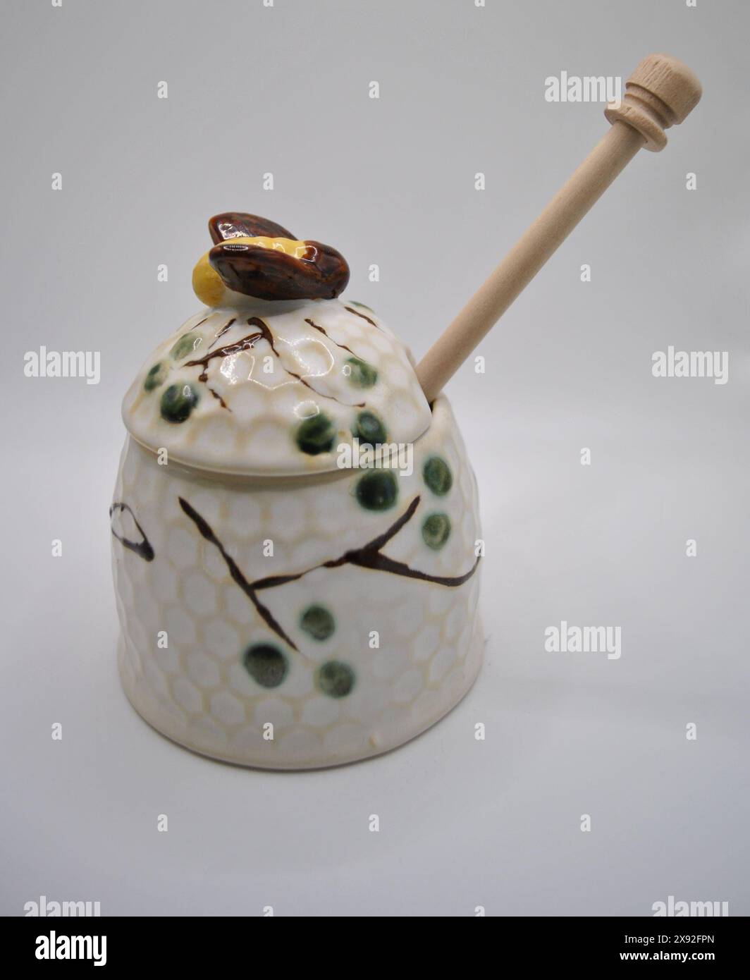 Ceramic Beehive Honey Pot and Wooden Dipper on White Background Stock ...