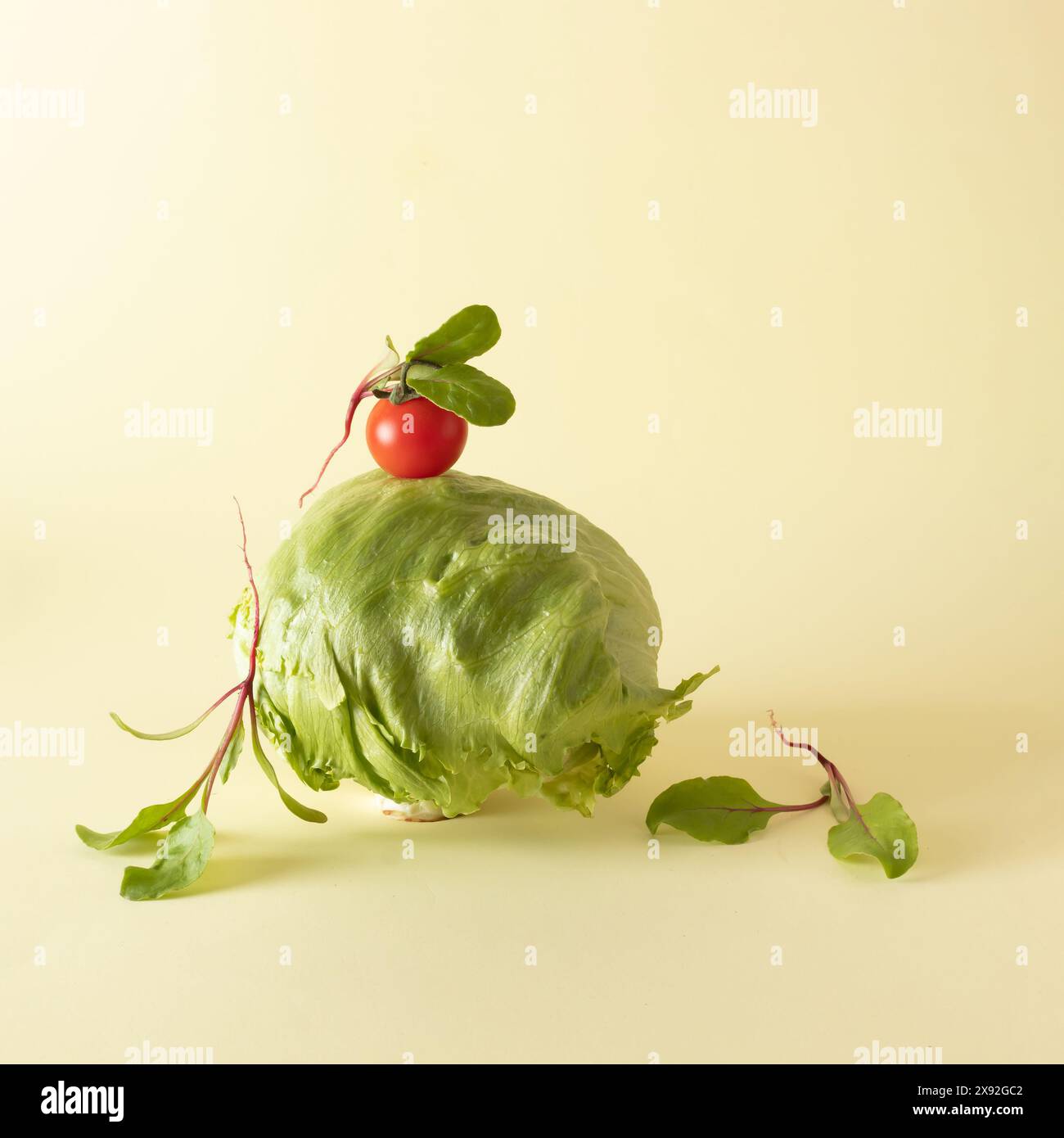Quirky and fun still life of vegetables iceberg lettuce, cherry tomato ...