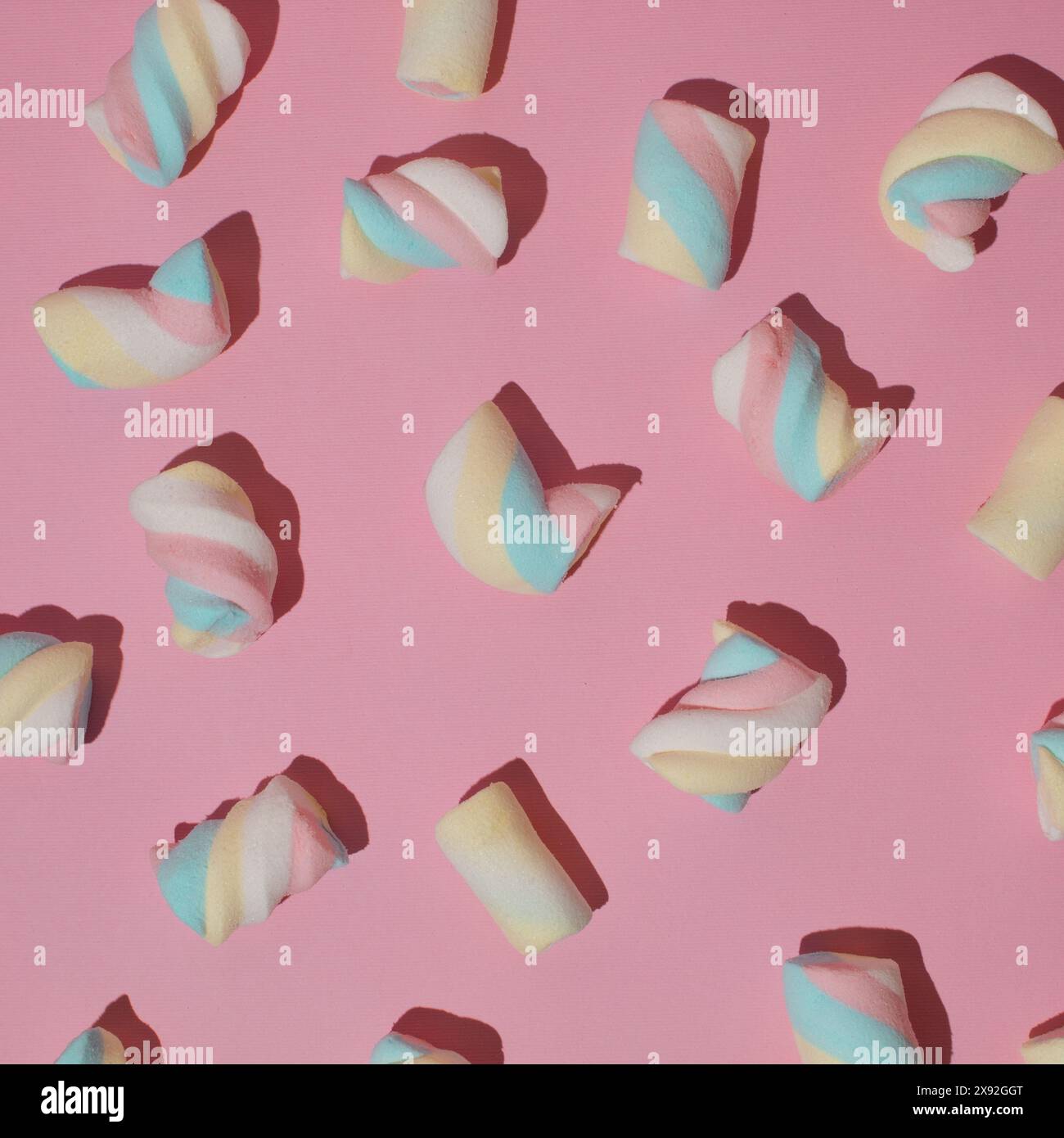 Marshmallows lined up on a pink background Stock Photo - Alamy