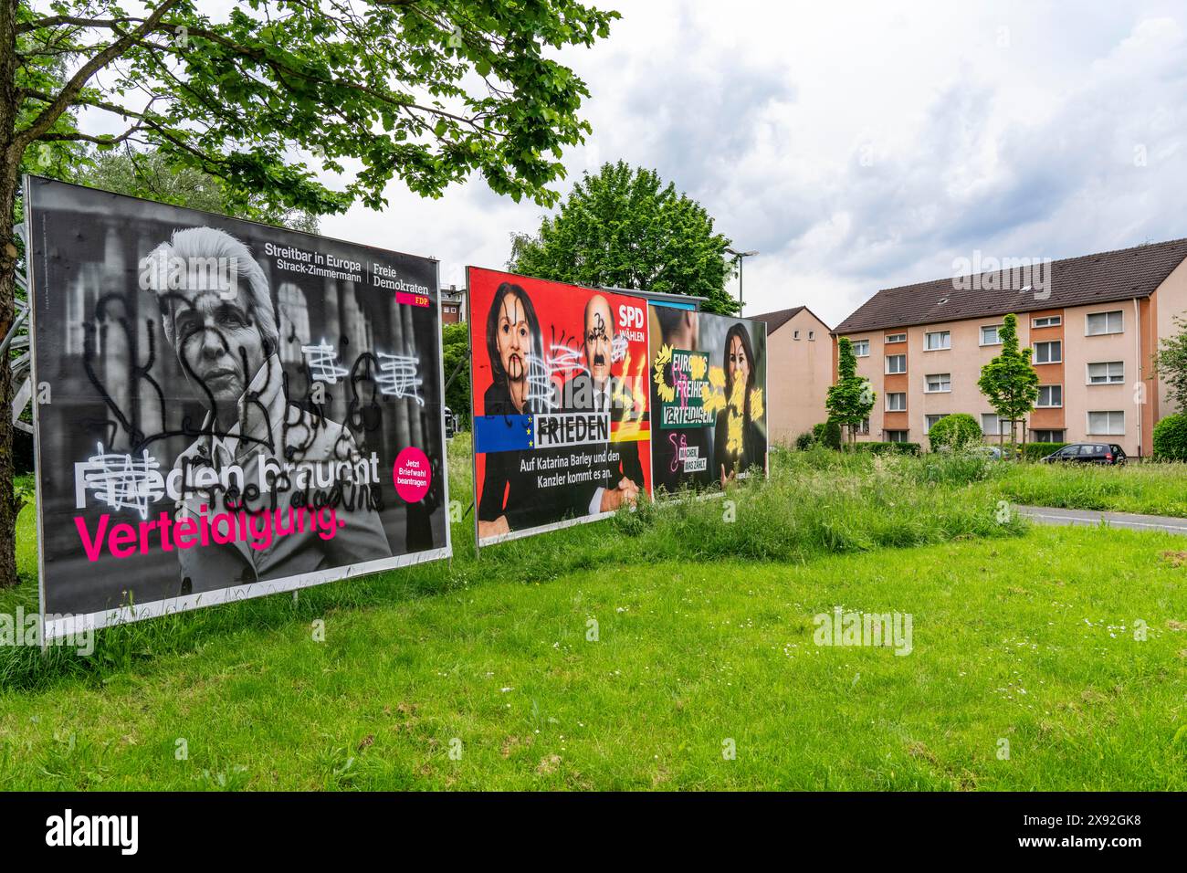 Graffitied election posters of FDP, SPD, Greens, smeared with symbols ...