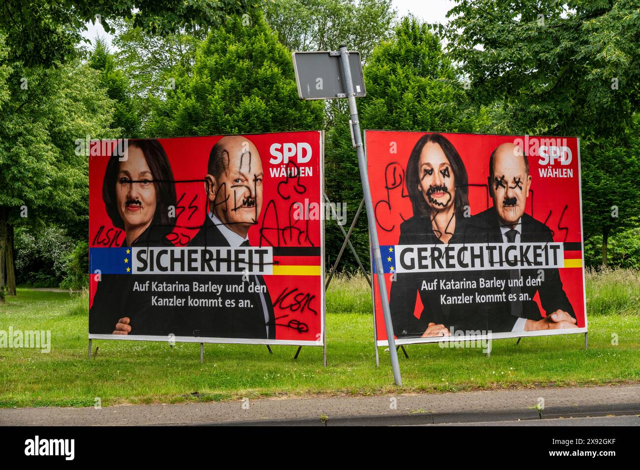 Graffitied election posters of the SPD, smeared with symbols and ...