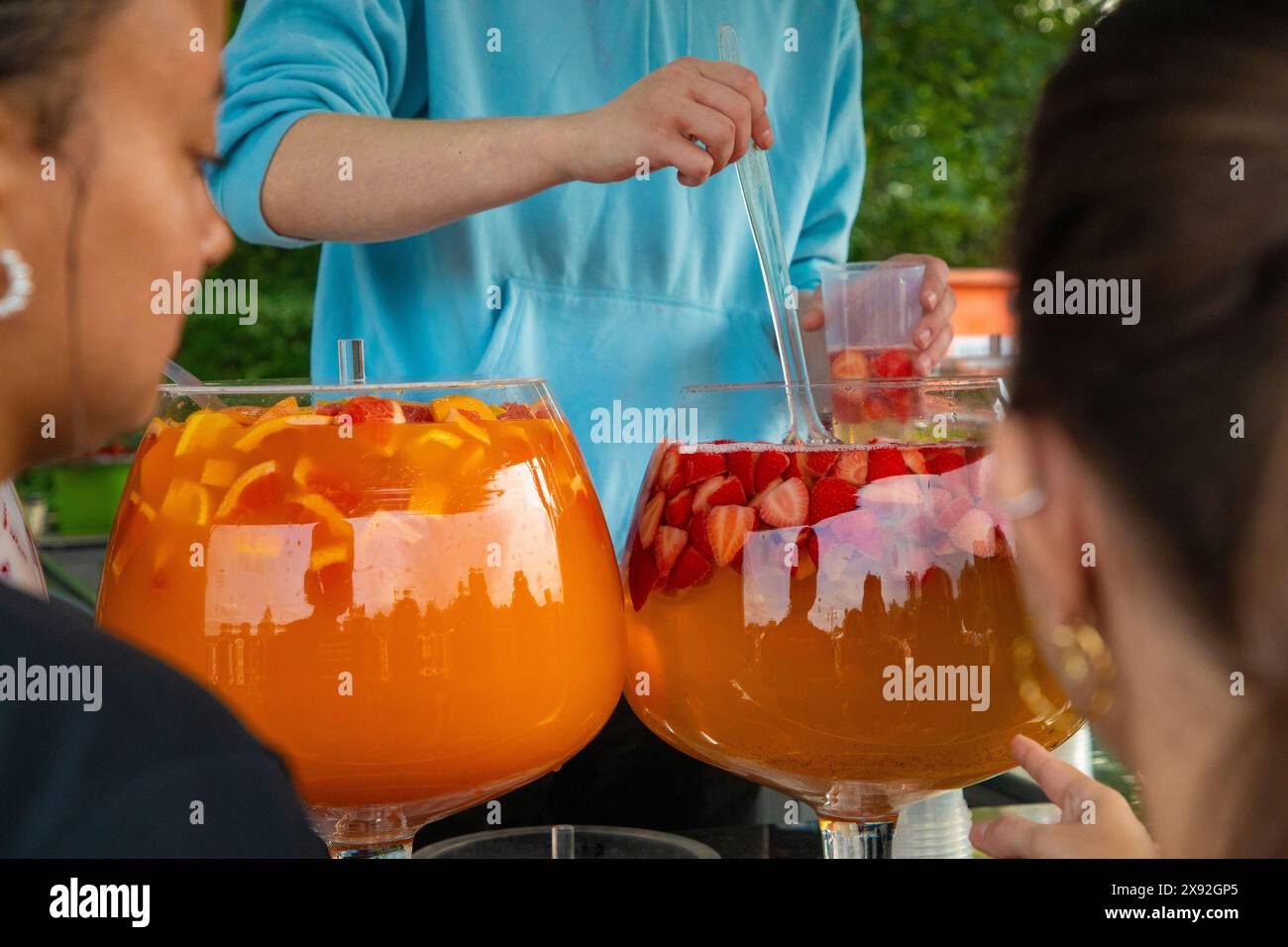 row of large glass bowls filled with various colorful beverages ...