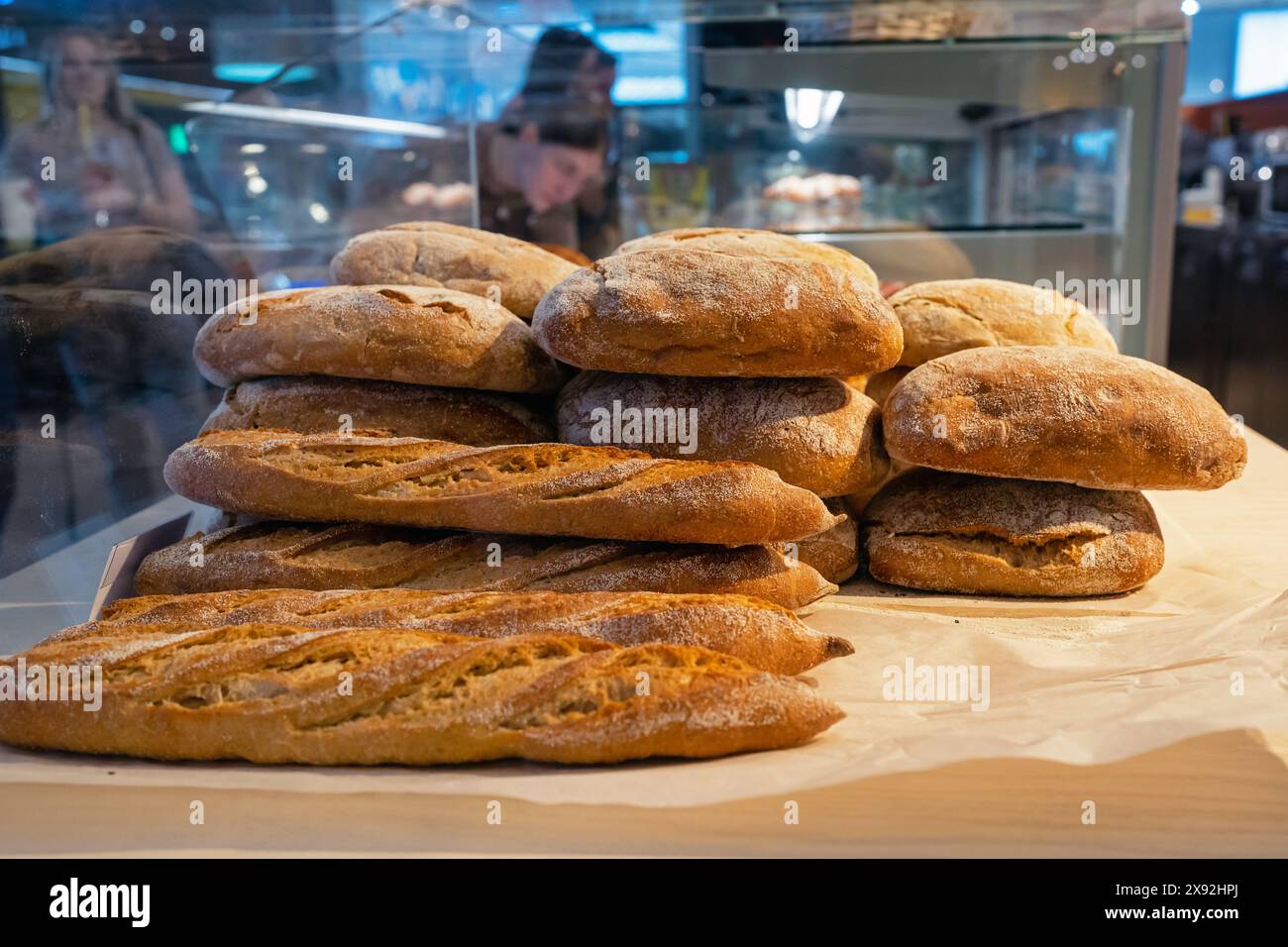 Different kinds of fresh breads, baguettes and ciabatta on display of ...