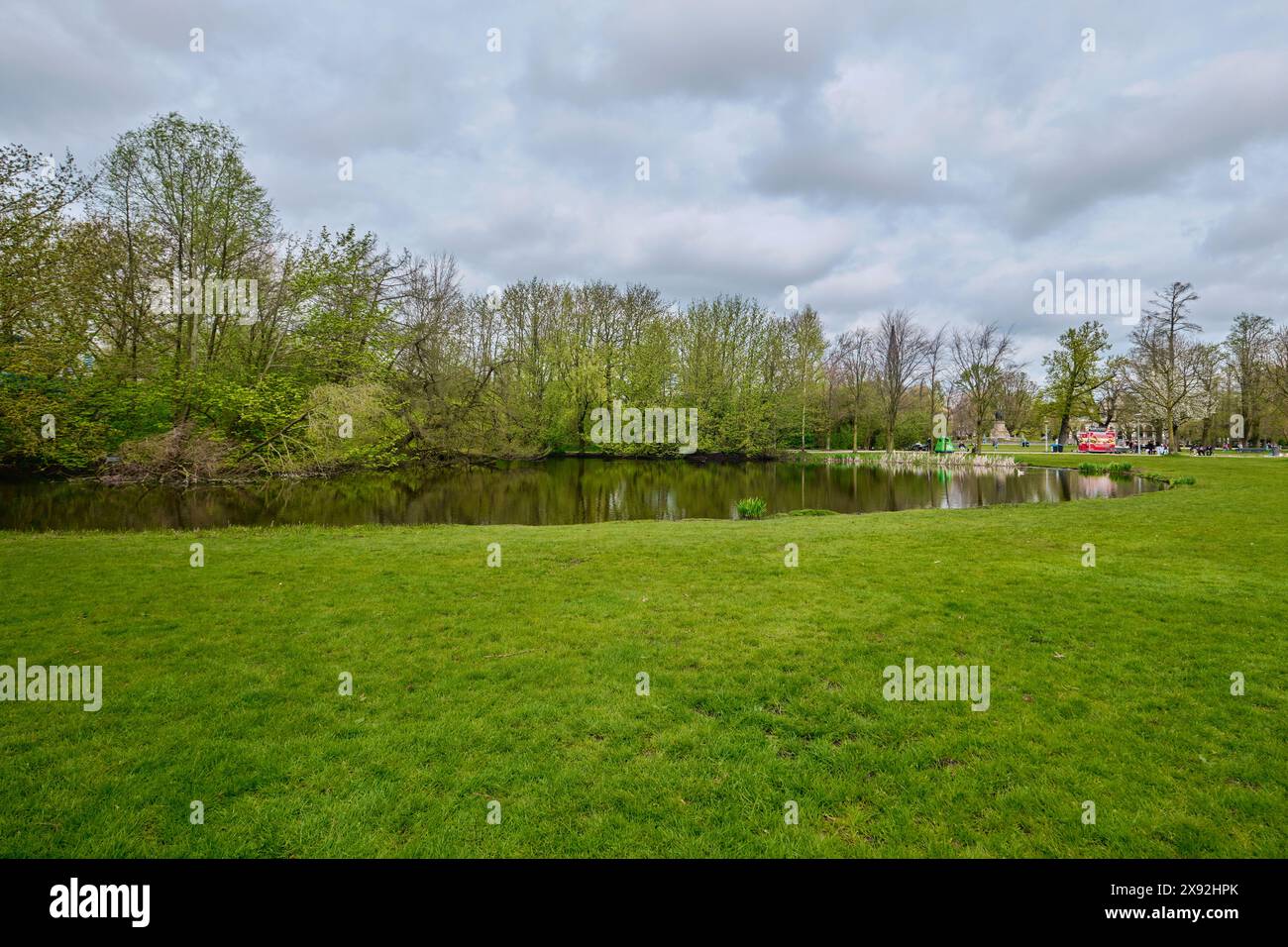 Netherlands, Amsterdam - April 10, 2024: Grass field and pond at ...