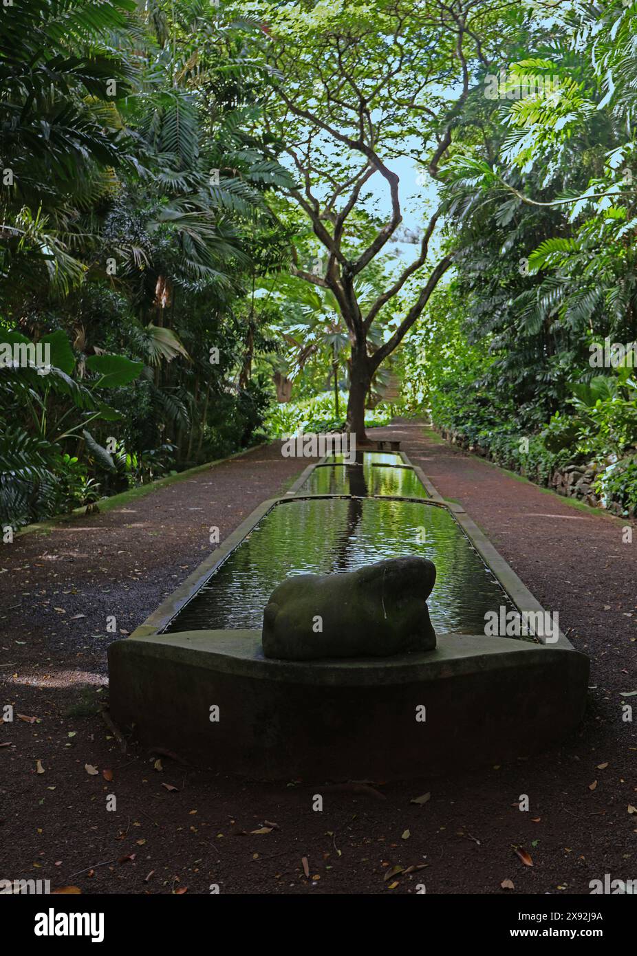 Looking down a three tiered reflection pond, with gravel paths and ...
