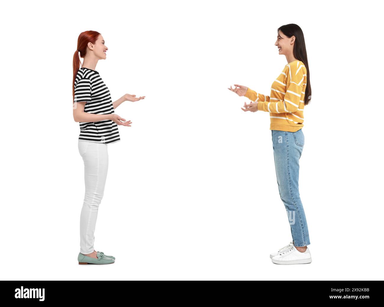 Two women talking on white background. Dialogue Stock Photo - Alamy