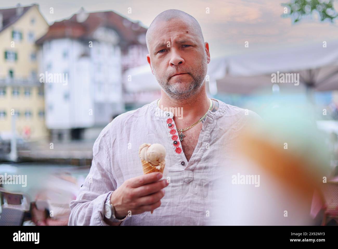 European tourist eating ice cream standing at street outside Stock ...