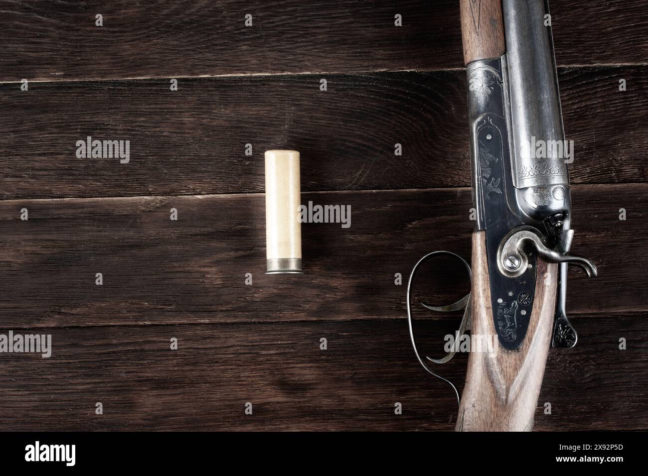 double barreled side shotgun with paper cartridge on wooden table Stock ...