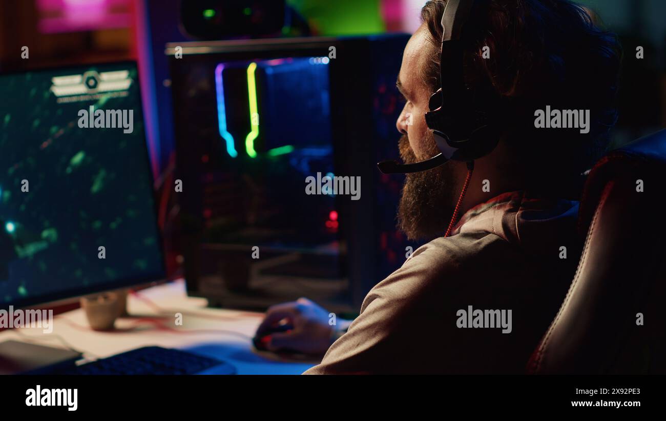 Close up shot of computer screen showing spaceship flying singleplayer game with overlay HUD ...