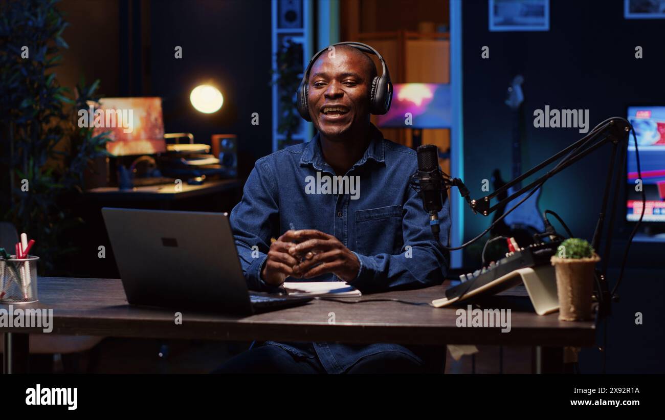 Cheerful content creator using outlined ideas on notebook to film vlog ...