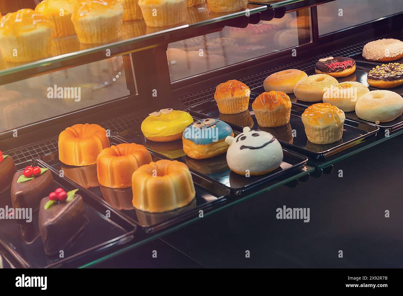 Small cakes on display at the patisserie counter Stock Photo - Alamy