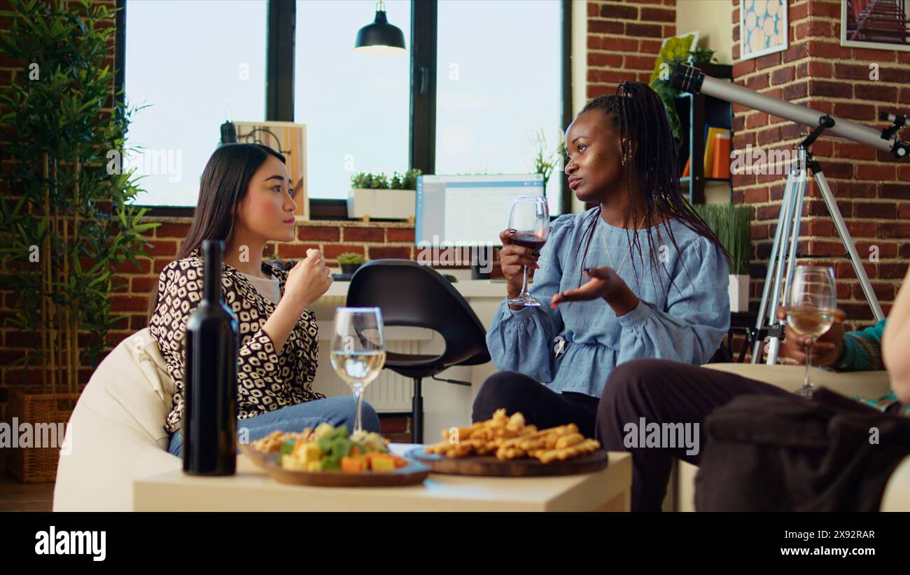 Multiracial women at brunch gathering trying out gourmet cheese from ...