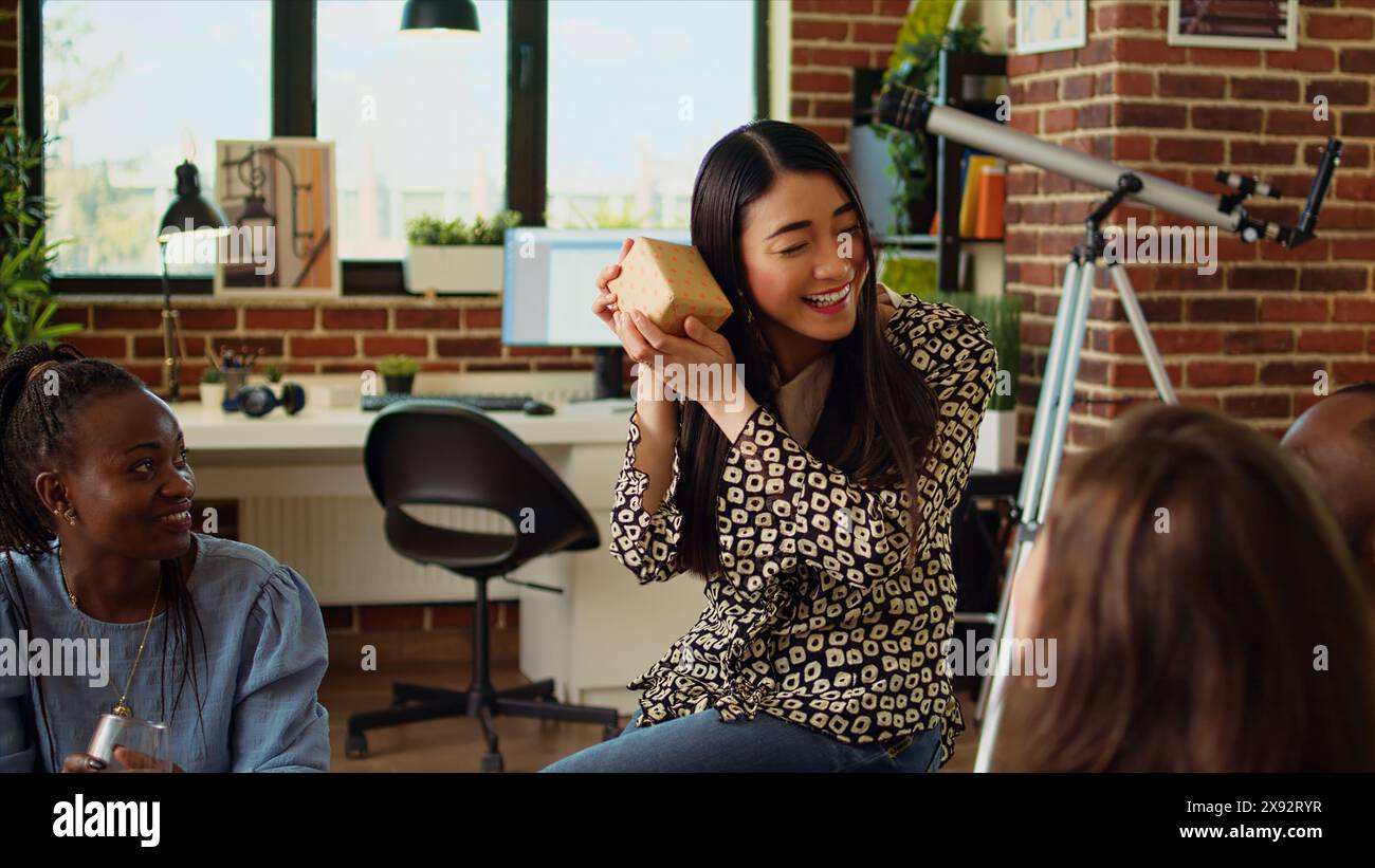 Multiethnic friends throwing surprise birthday party for asian woman ...