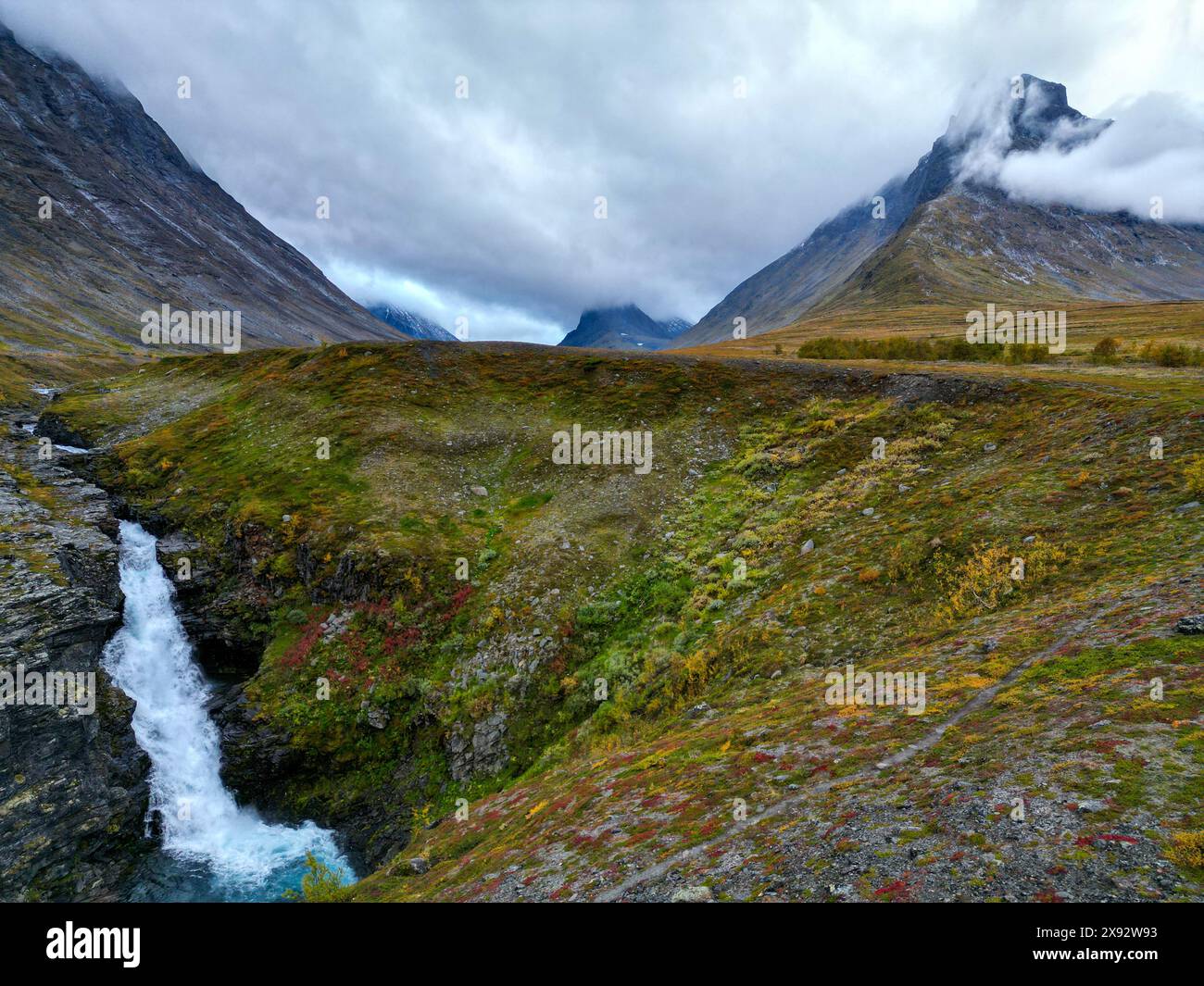 A waterfall and mountains of the Nallo Massif near Vistas Mountain Hut ...