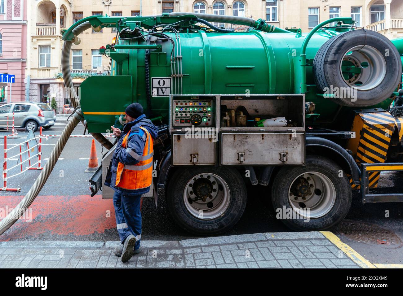 Worker near sewage cleaning vacuum truck. Septic cleaning vacuum ...