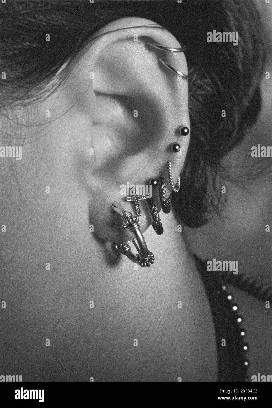 Women with multiply ear piercings black and white Stock Photo - Alamy