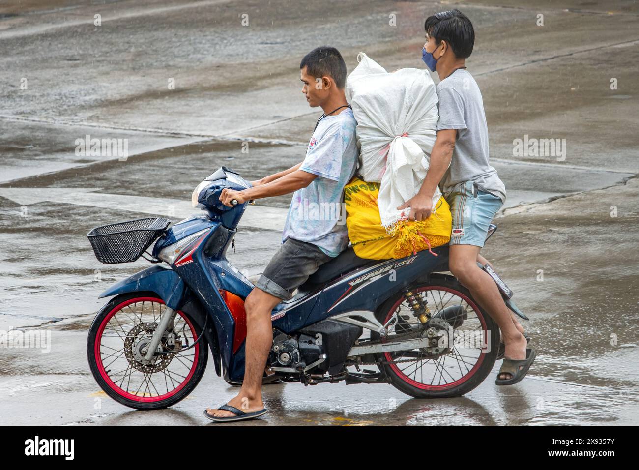 SAMUT PRAKAN, THAILAND, MAY 07 2024, Two men are transporting a large ...