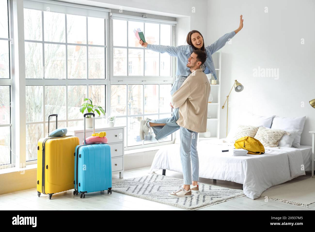 Happy tourists with passports checking in hotel room Stock Photo - Alamy
