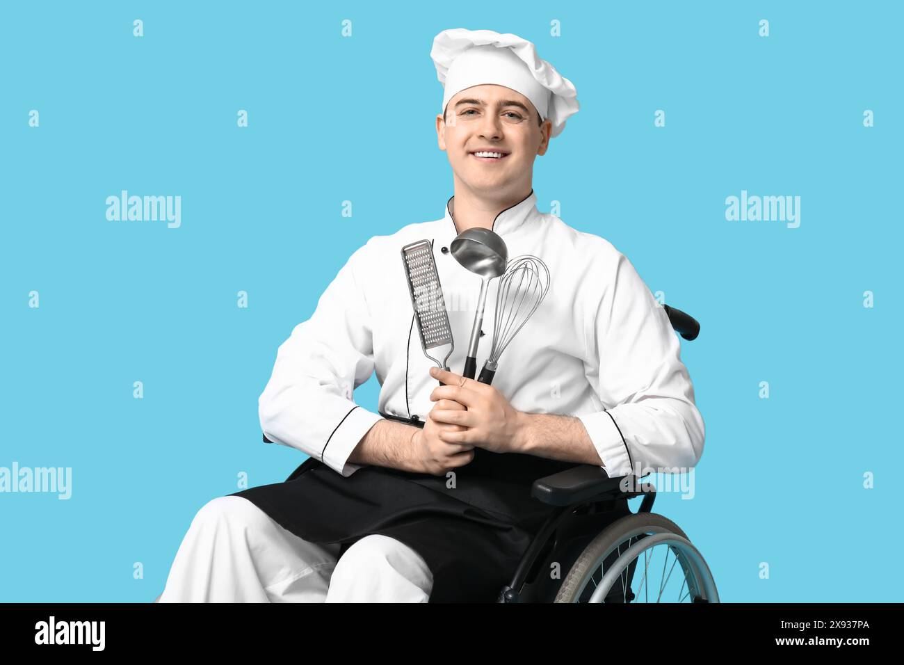 Male chef in wheelchair with kitchen utensils on blue background Stock ...