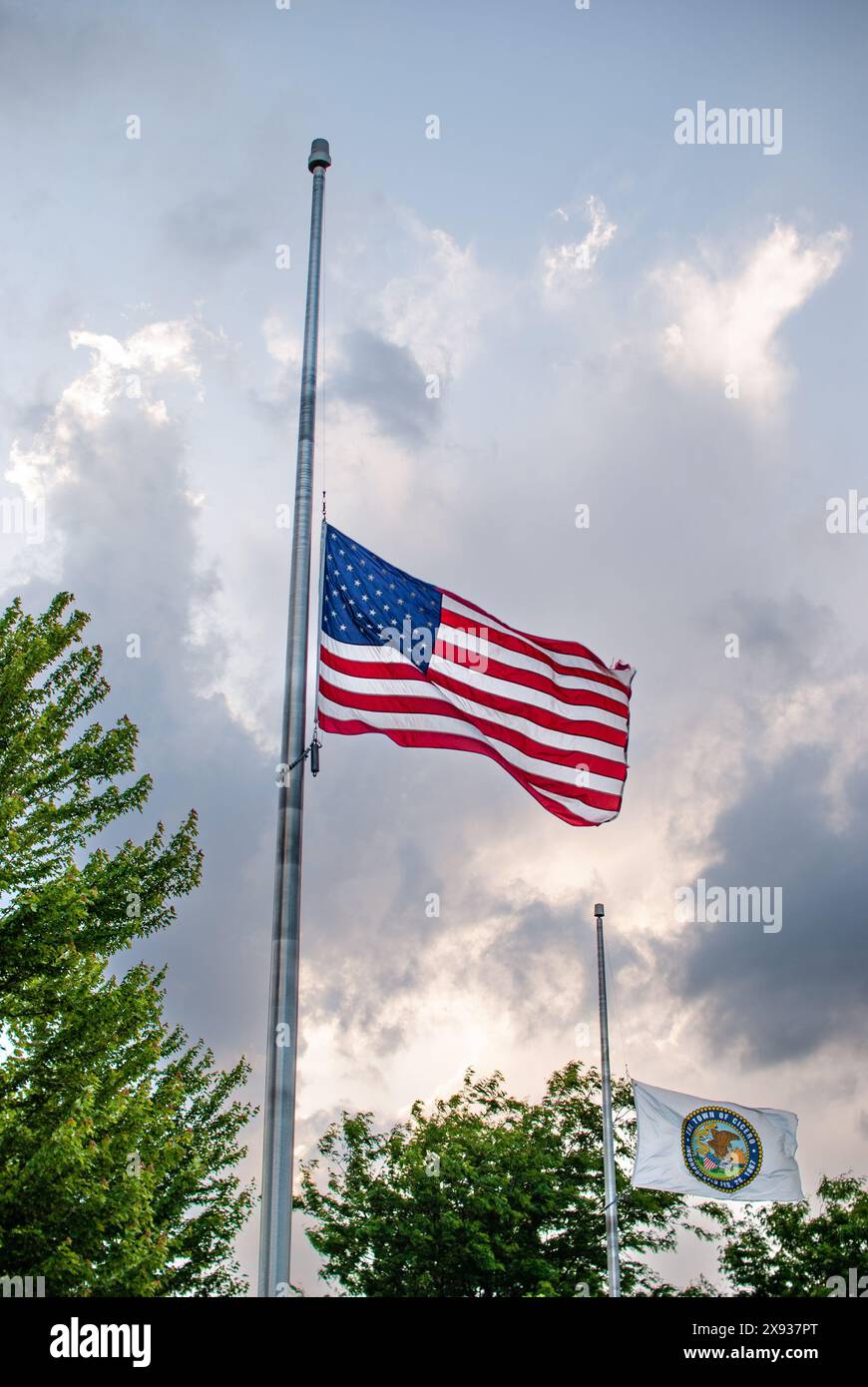 American flag at half mast for memorial day weekend on a sunny day ...