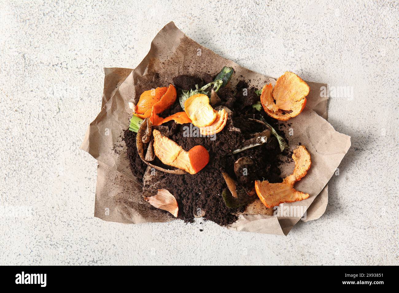 Paper with organic waste and soil on white grunge background. Compost ...