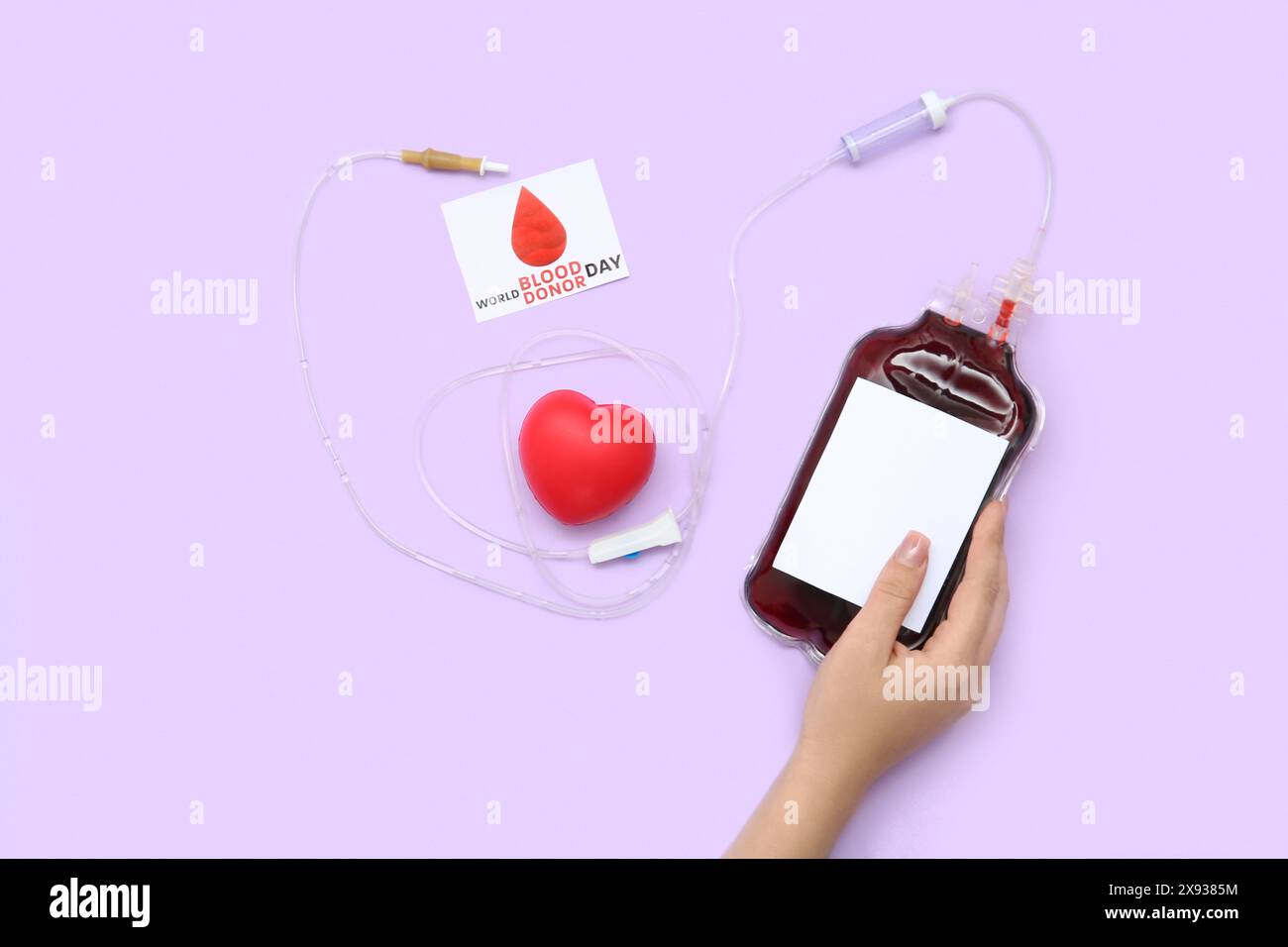Female hand holding blood pack for transfusion, heart and paper sheet ...