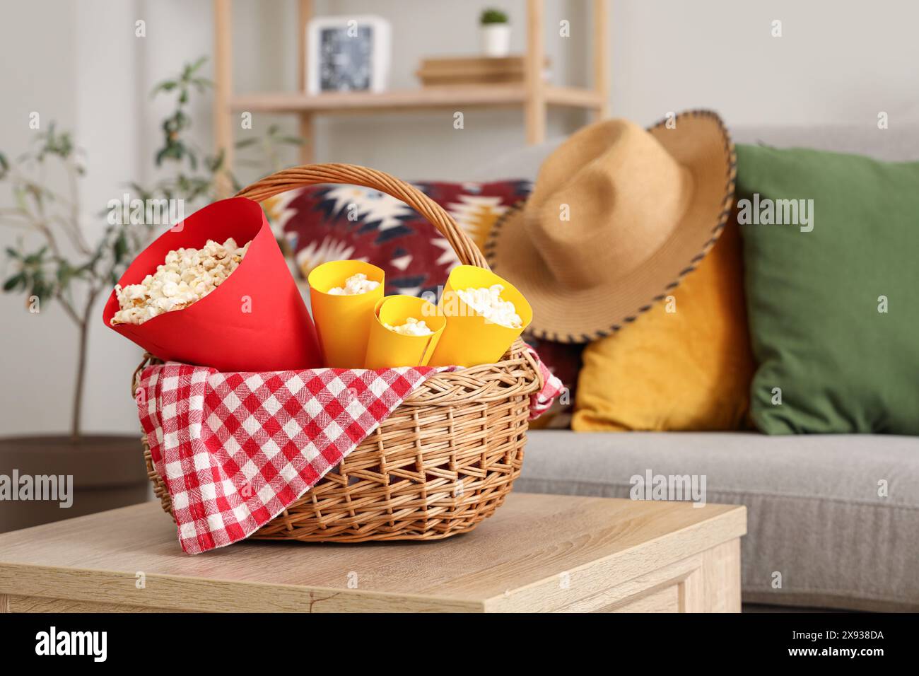 Wicket basket with popcorn on coffee table in living room. Festa Junina ...