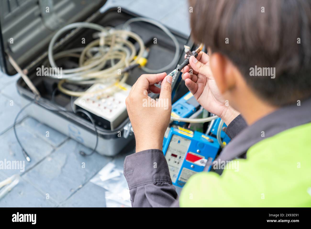 Technician ware sampling tube air quality in reel of machine pump for ...