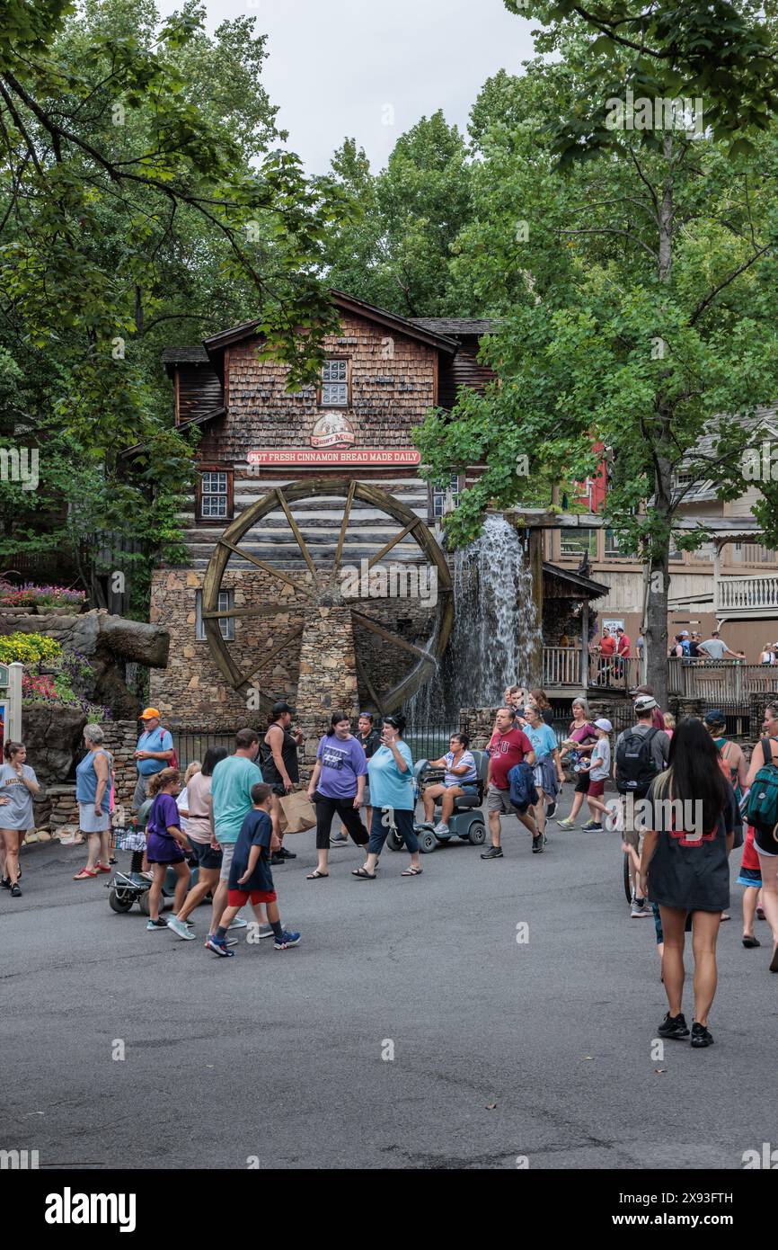 Park guests walking past the Dollywood Grist Mill at the Dollywood amusement park in Pigeon ...