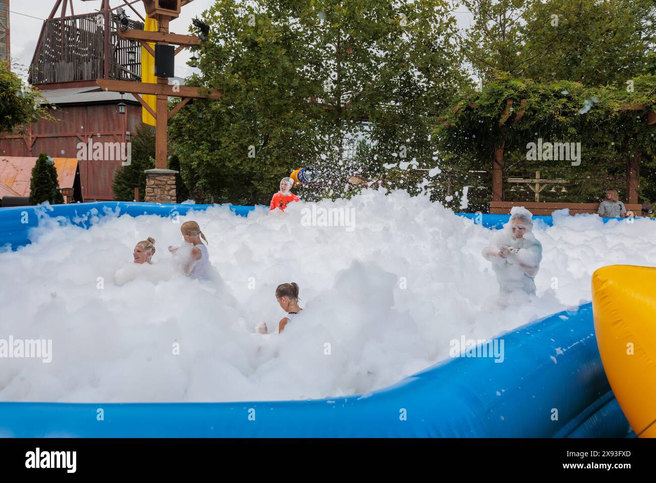 Park guests playing in the bubble foam pit at the Dollywood amusement ...