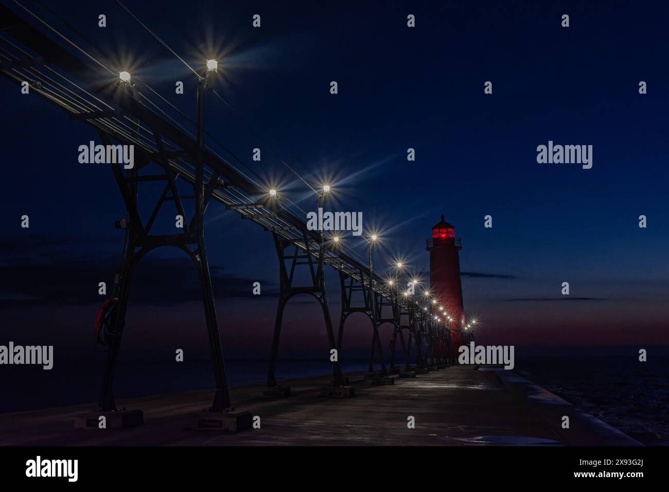 Lights illuminate the Grand Haven, Michigan, pier and lighthouse as the ...