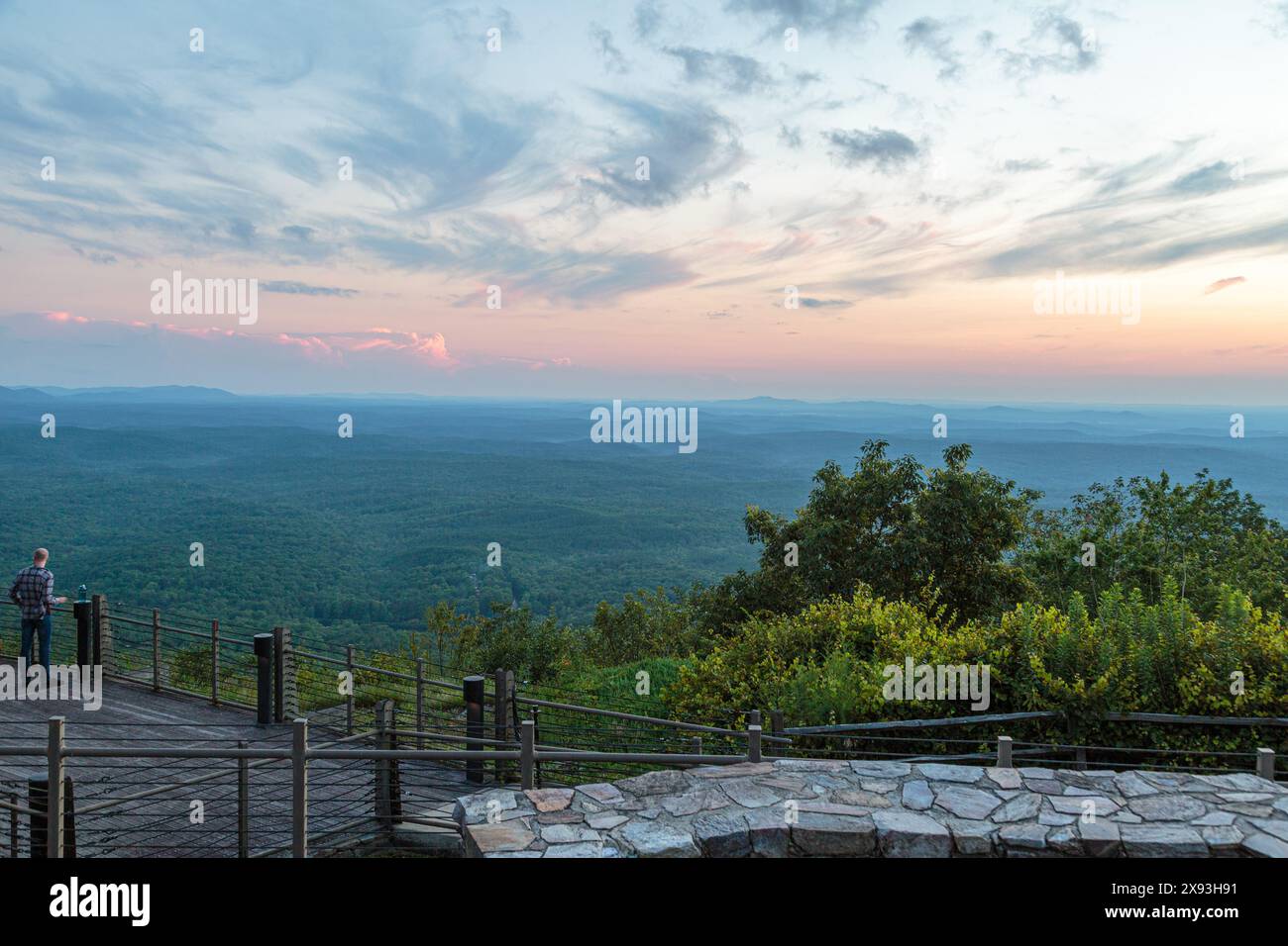 Man looking out over the valley at sunset from the Vista Cliffside ...