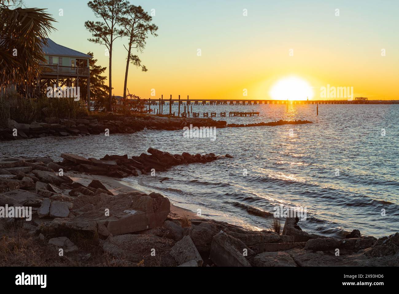 Sunset over the railroad bridge across Bay of Saint Louis from ...