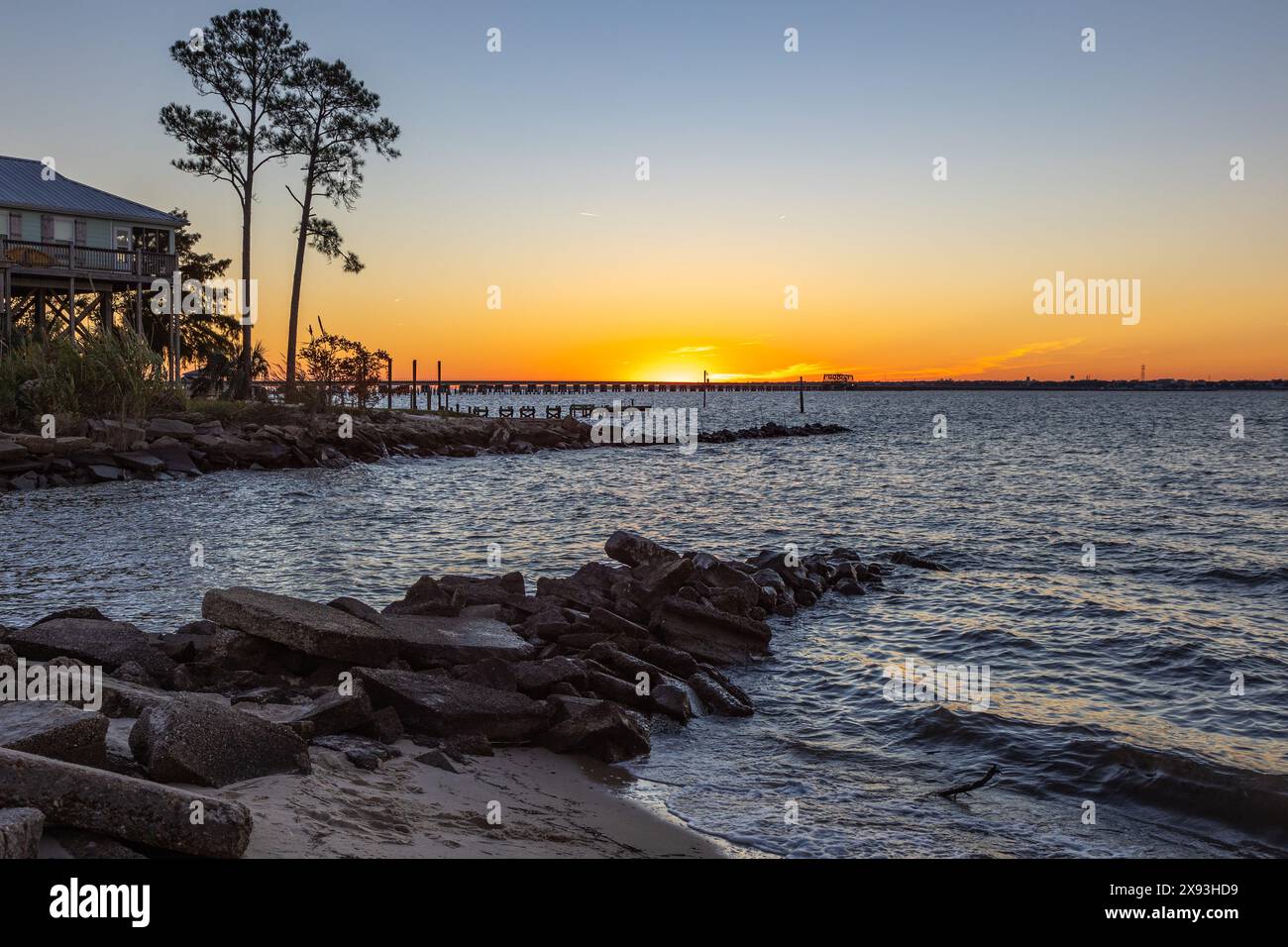 Sunset over the railroad bridge across Bay of Saint Louis from ...