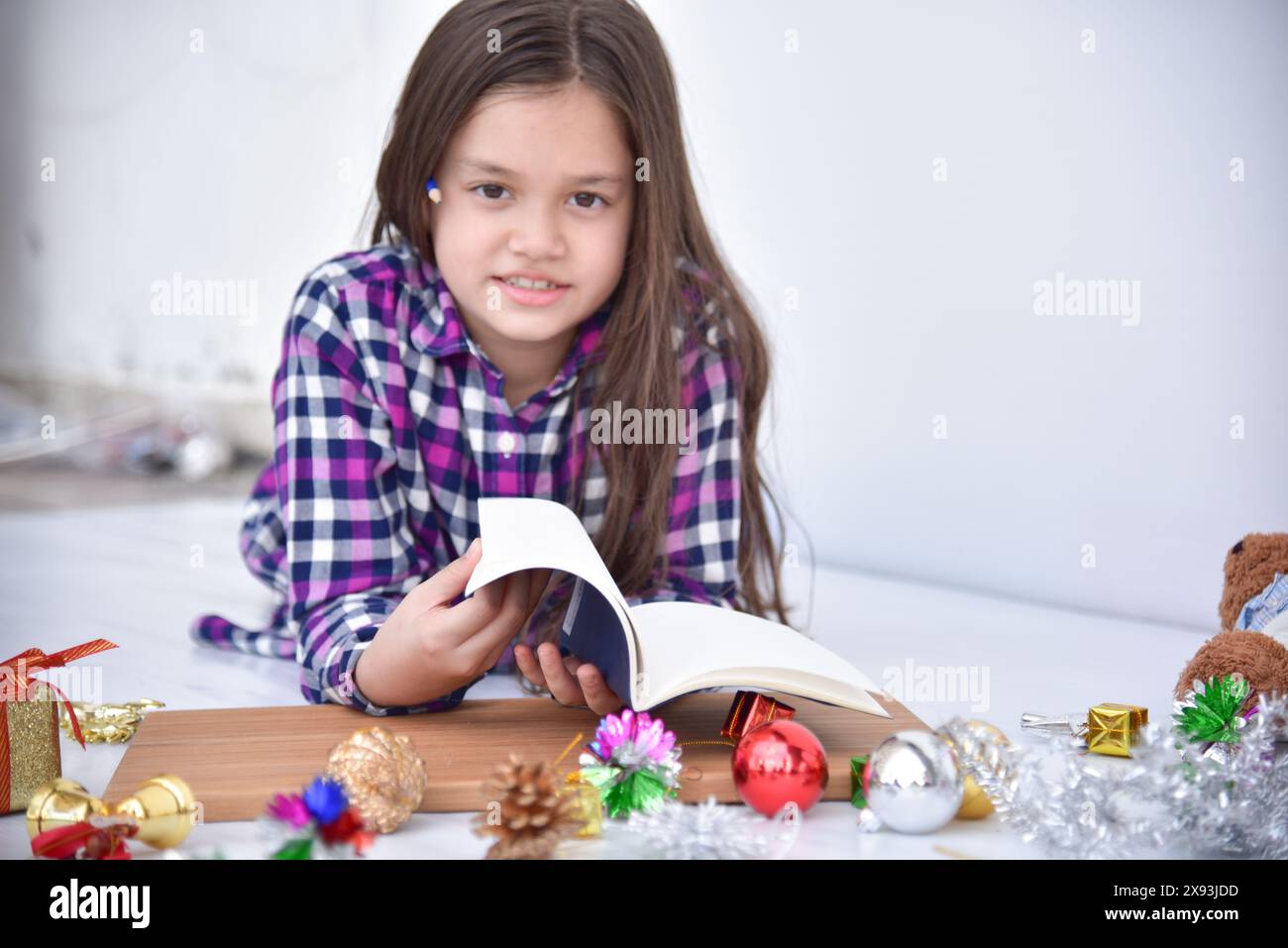 Kid reading book happy girl home school. American childhood lying down ...
