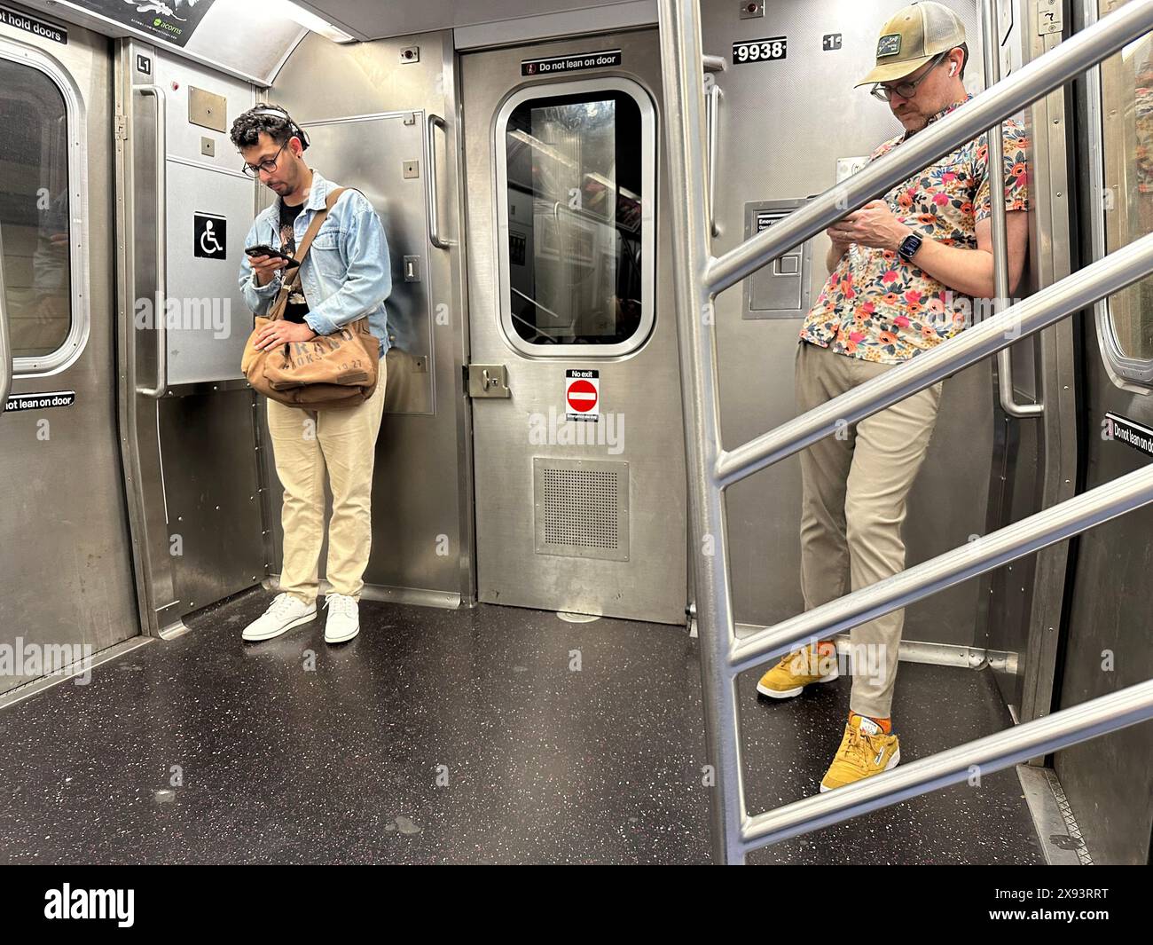 Men using smartphones on New York City subway Stock Photo - Alamy