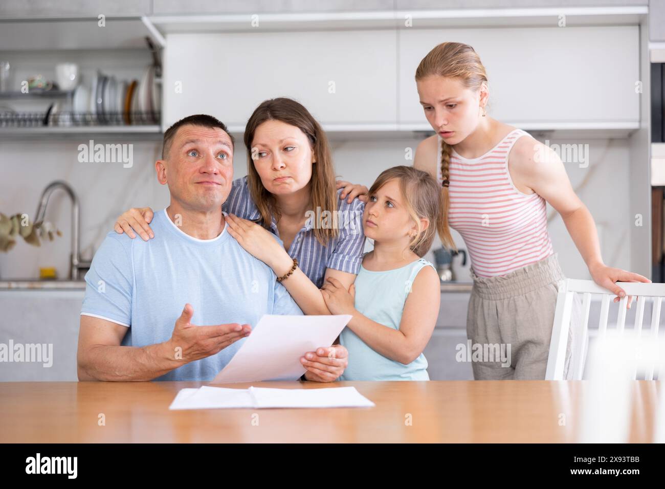 Unhappy family with documents having financial problems Stock Photo - Alamy