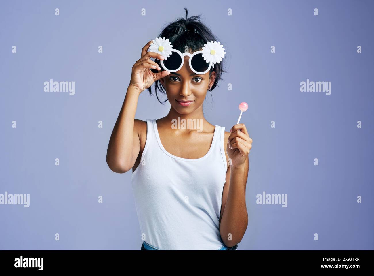Girl, portrait and flower sunglasses with lollipop as gen z on blue ...