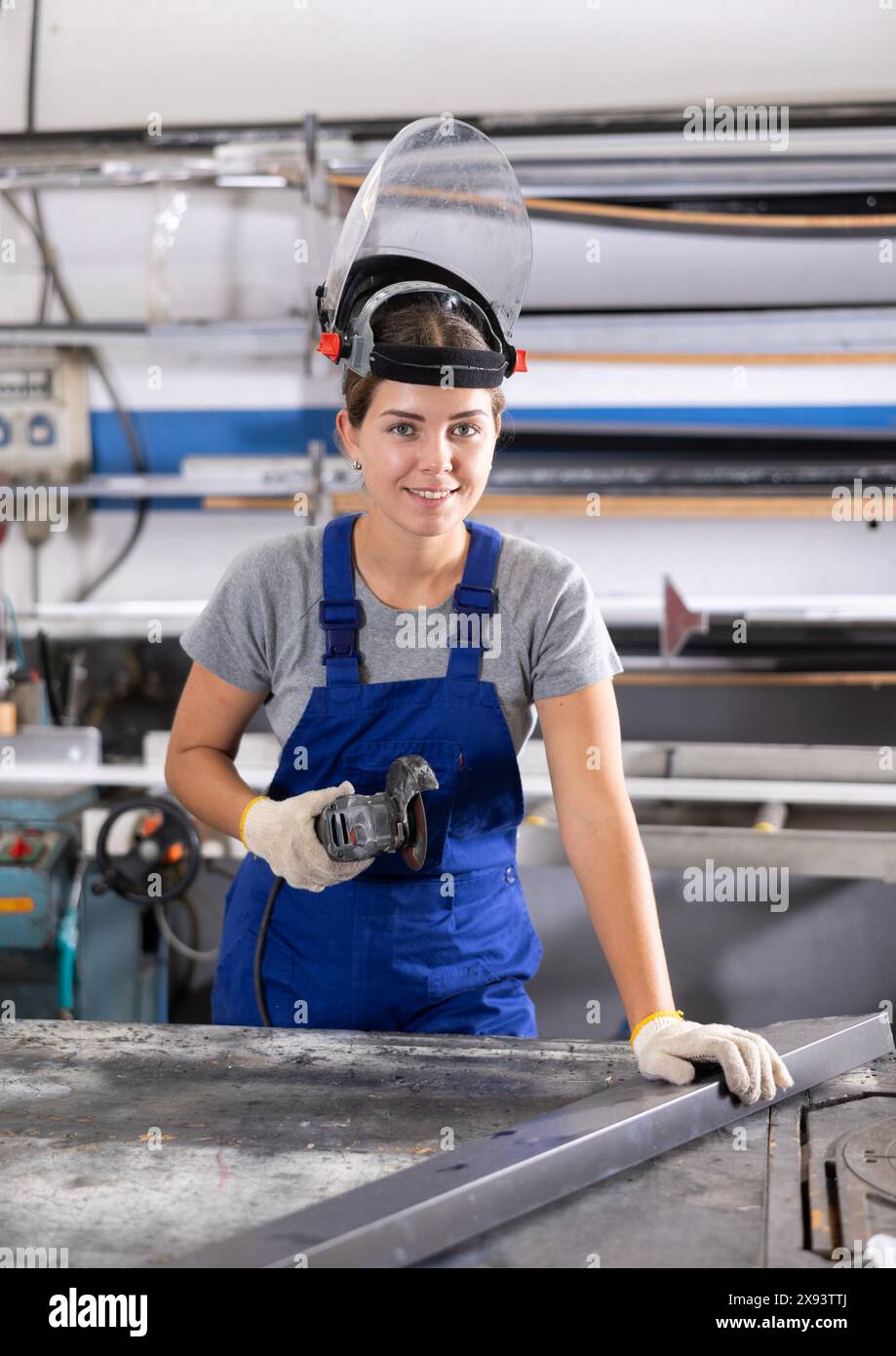 Woman cutting aluminum profile for windows using angle grinder Stock ...