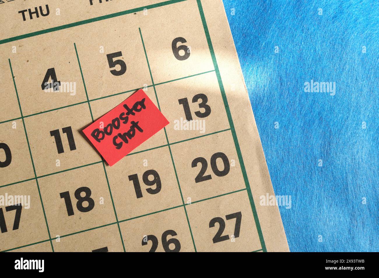 Booster dose vaccine shot schedule concept. Written reminder note on ...