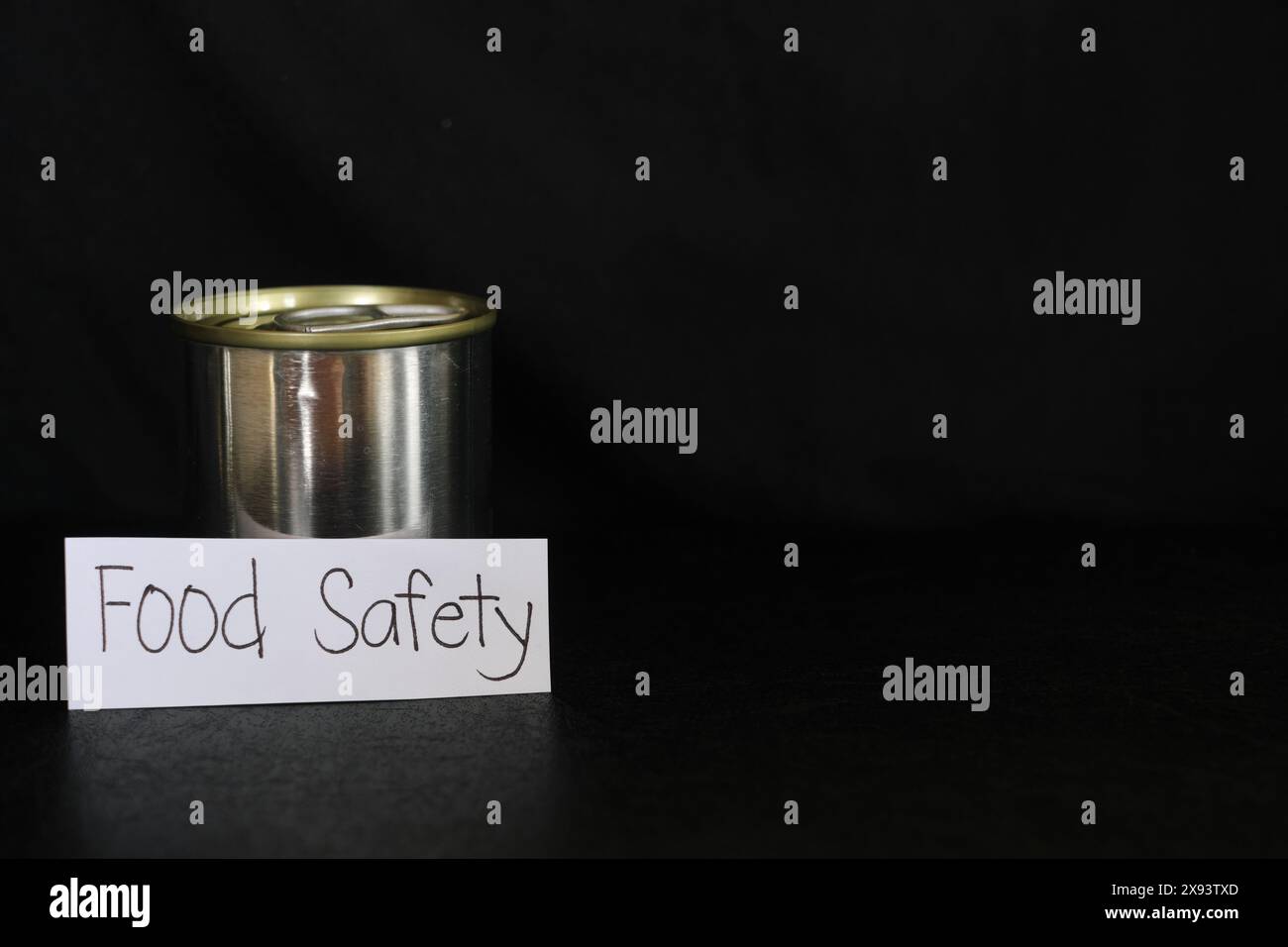 Food safety concept. Labeled canned food in dark black background Stock ...