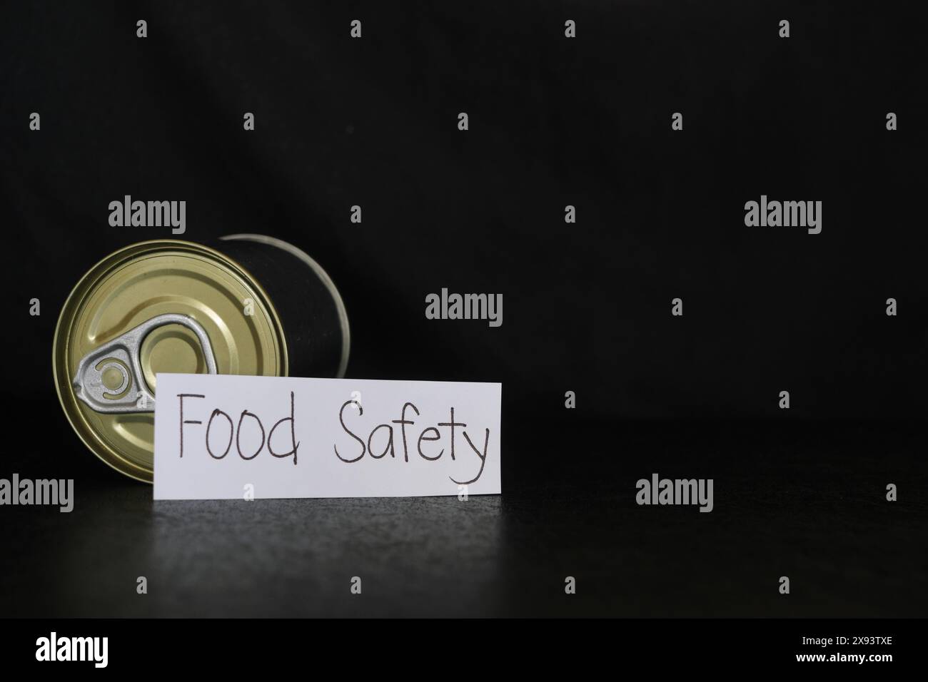 Food safety concept. Labeled canned food in dark black background Stock ...