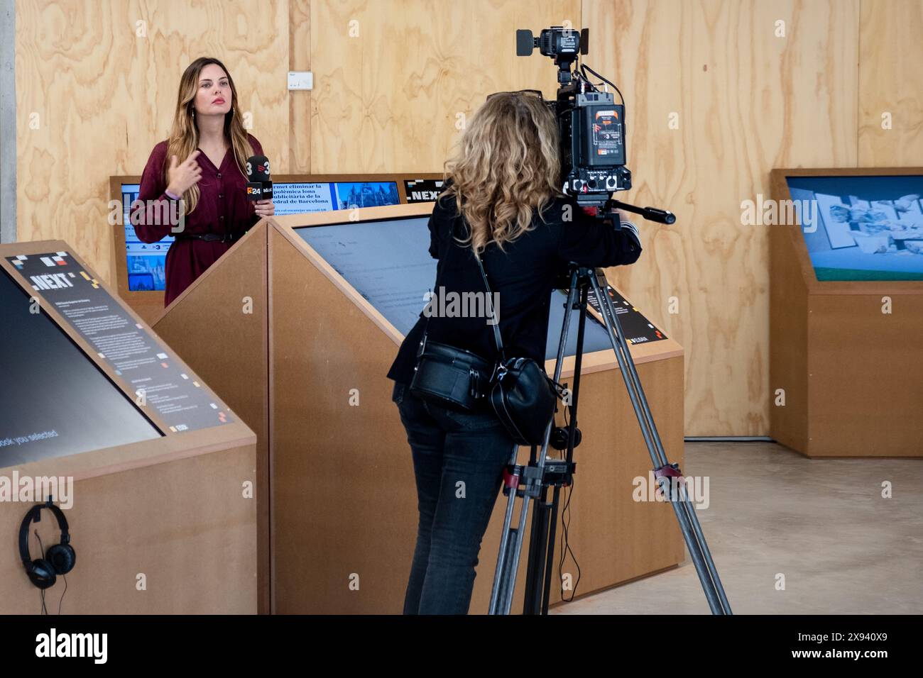 A local film crew records a news item in the Next Room Exhibit at OFFF ...