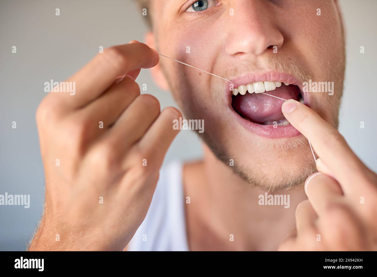 Self care, portrait and man flossing teeth in home for health, grooming and morning routine ...