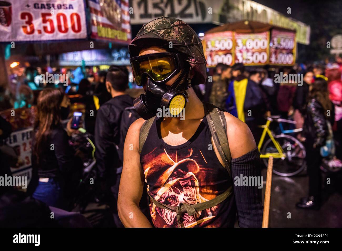A protester with a gas mask and a helmet takes part during the ...