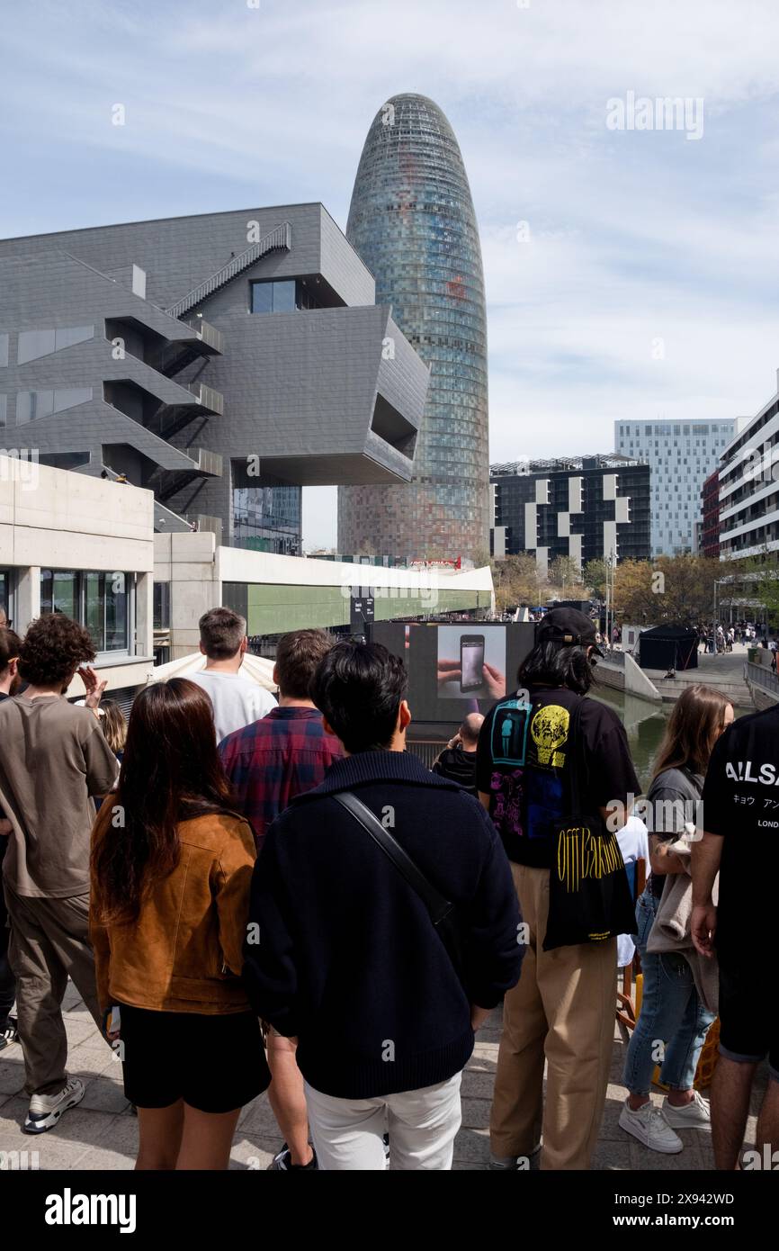 Attendees sat outside in the sunshine watch talks from the Open Room ...