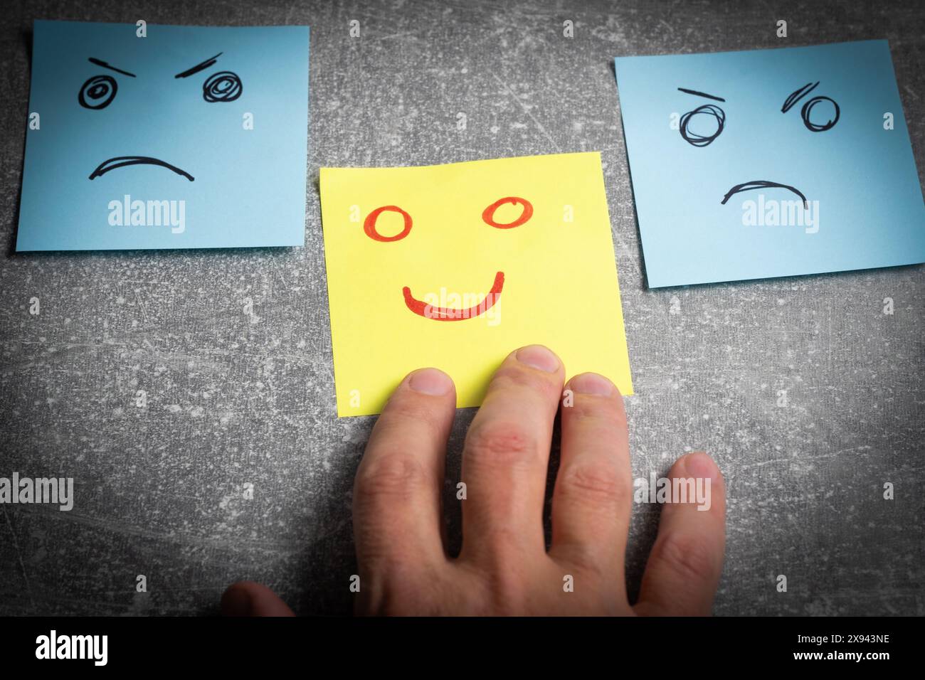 Two angry and cheerful emotions. Hand pulls out positive emotion from ...