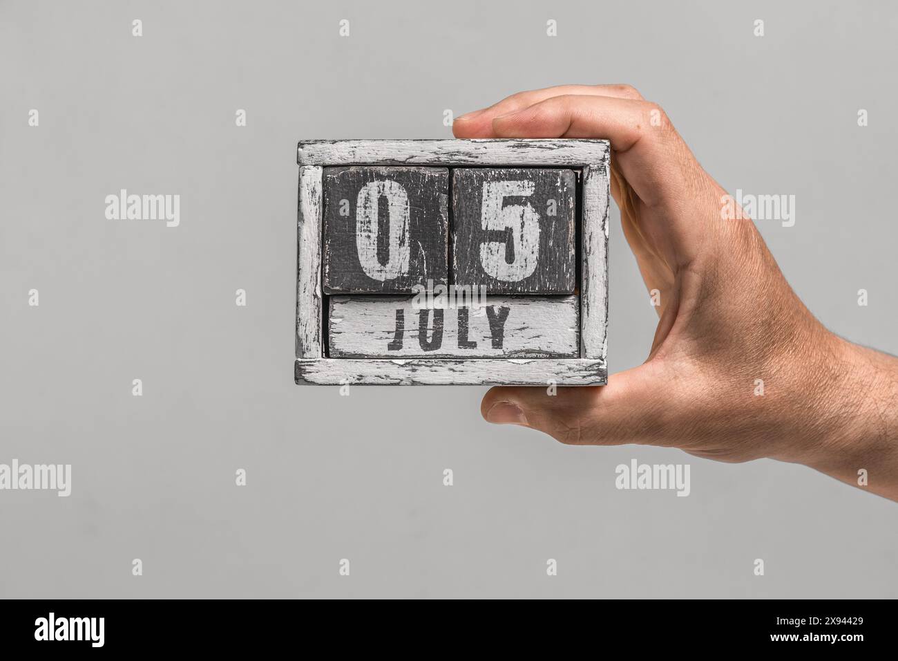 Date is July 05. Wooden calendar in hand on gray background Stock Photo ...